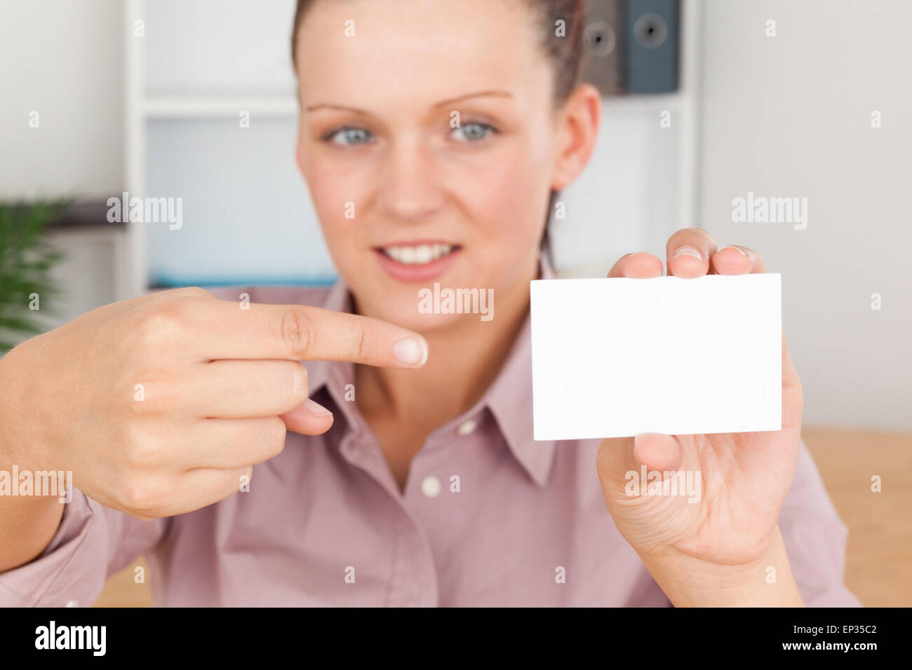 Business woman pointing at a card Stock Photo - Alamy