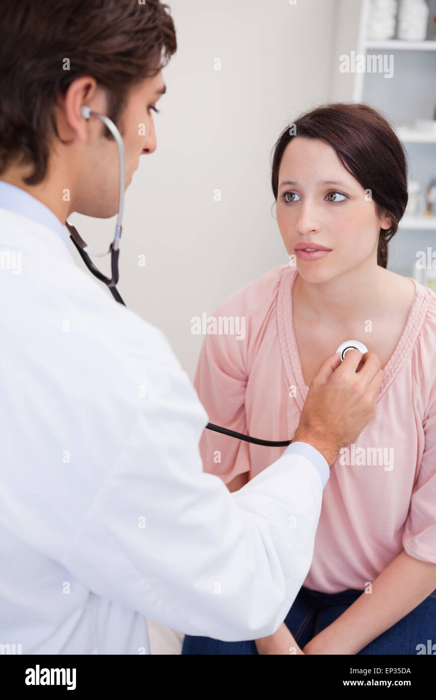 Doctor taking his patients heart beat Stock Photo - Alamy