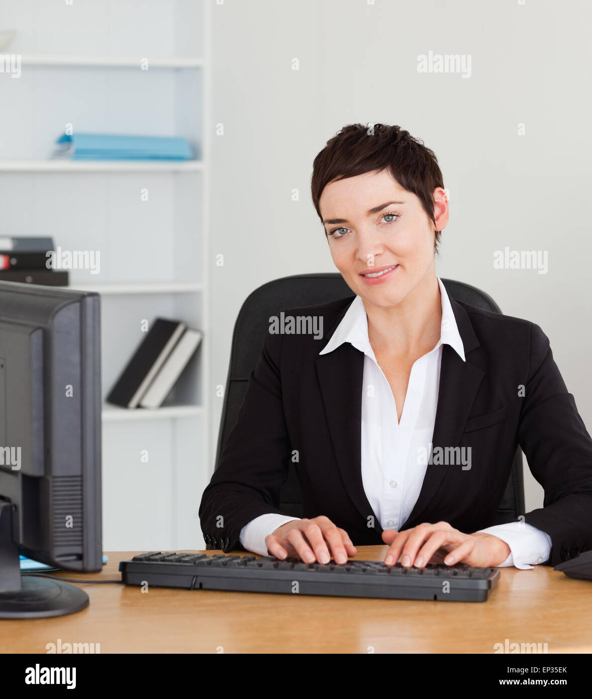 Portrait of a secretary typing on her keybord Stock Photo - Alamy