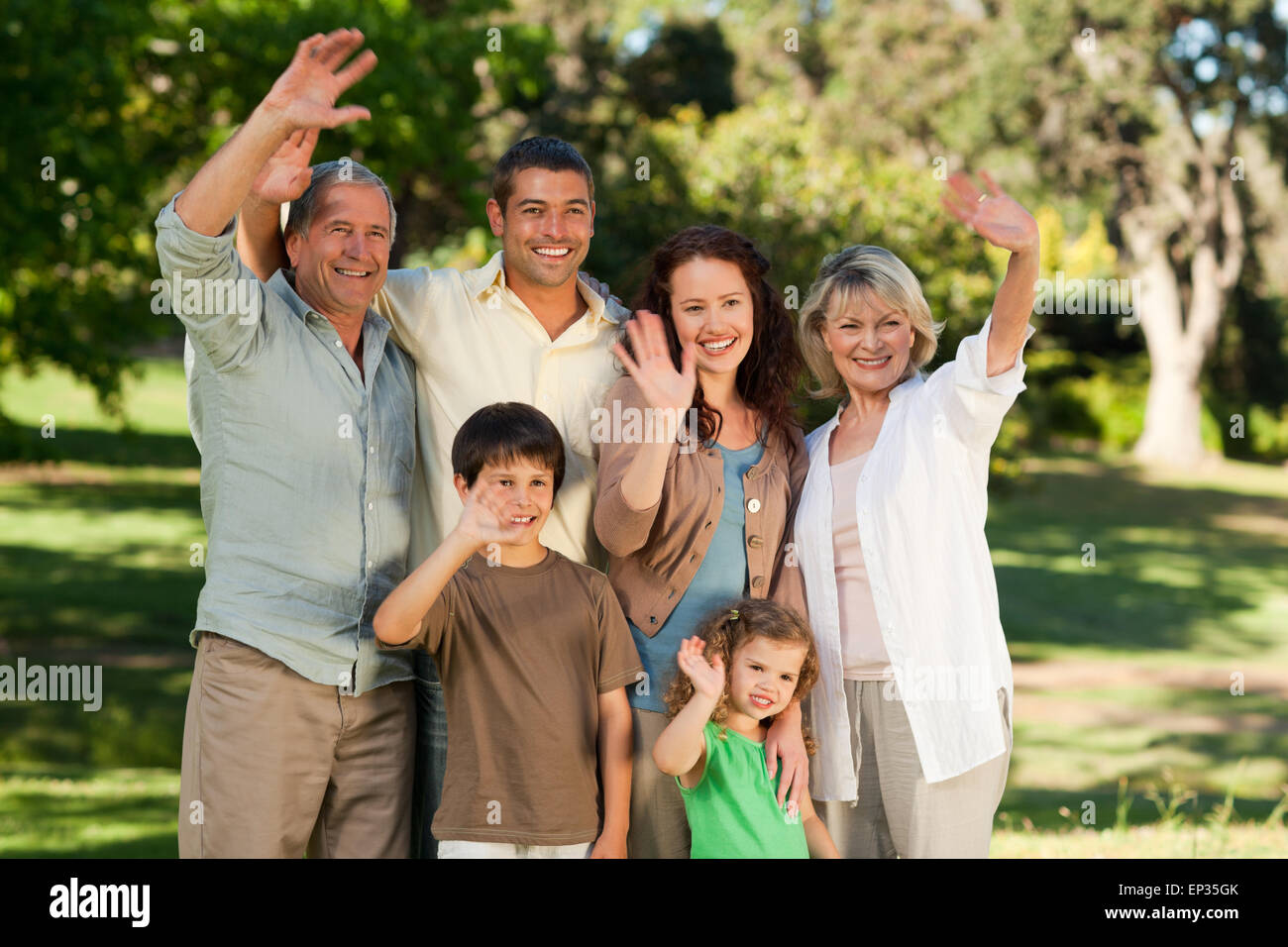 Family looking at the camera in the park Stock Photo - Alamy