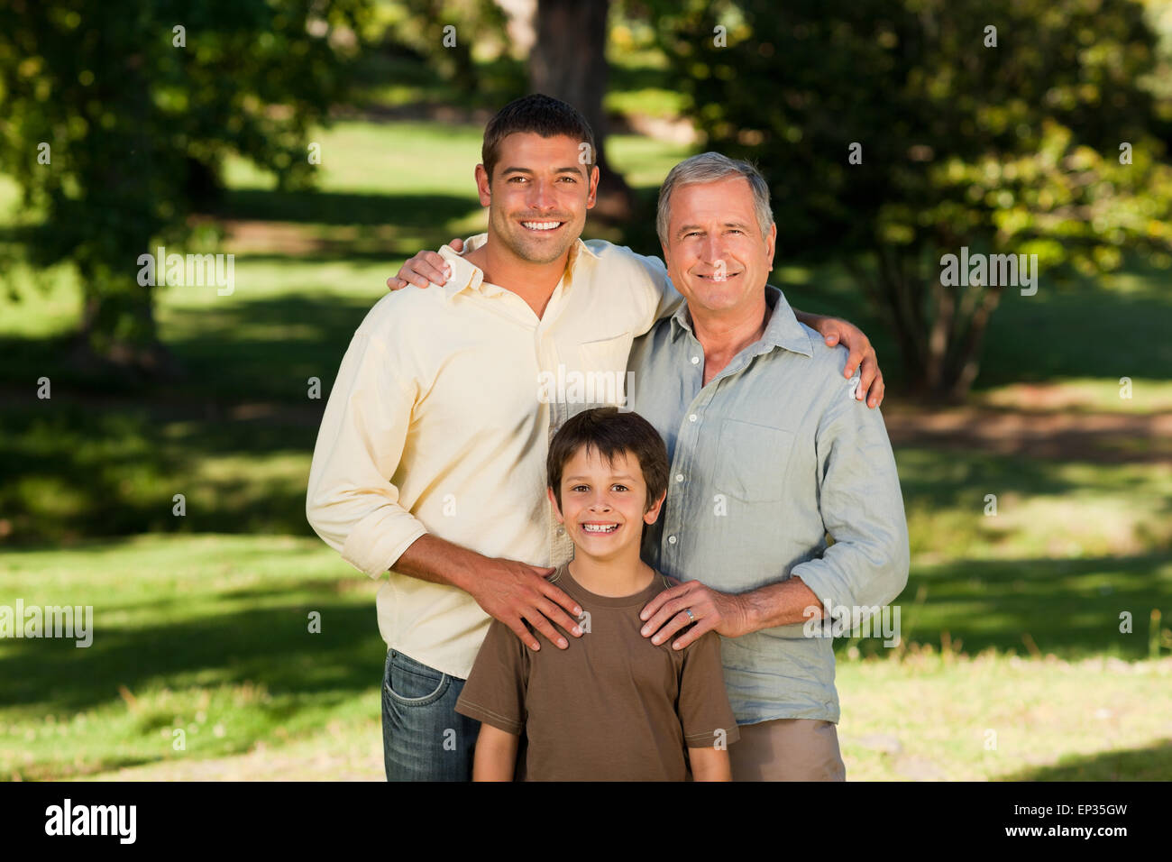Radiant family looking at the camera in the park Stock Photo - Alamy