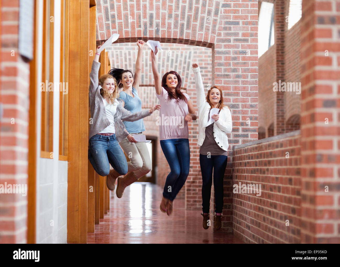 Students jumping with their results Stock Photo - Alamy