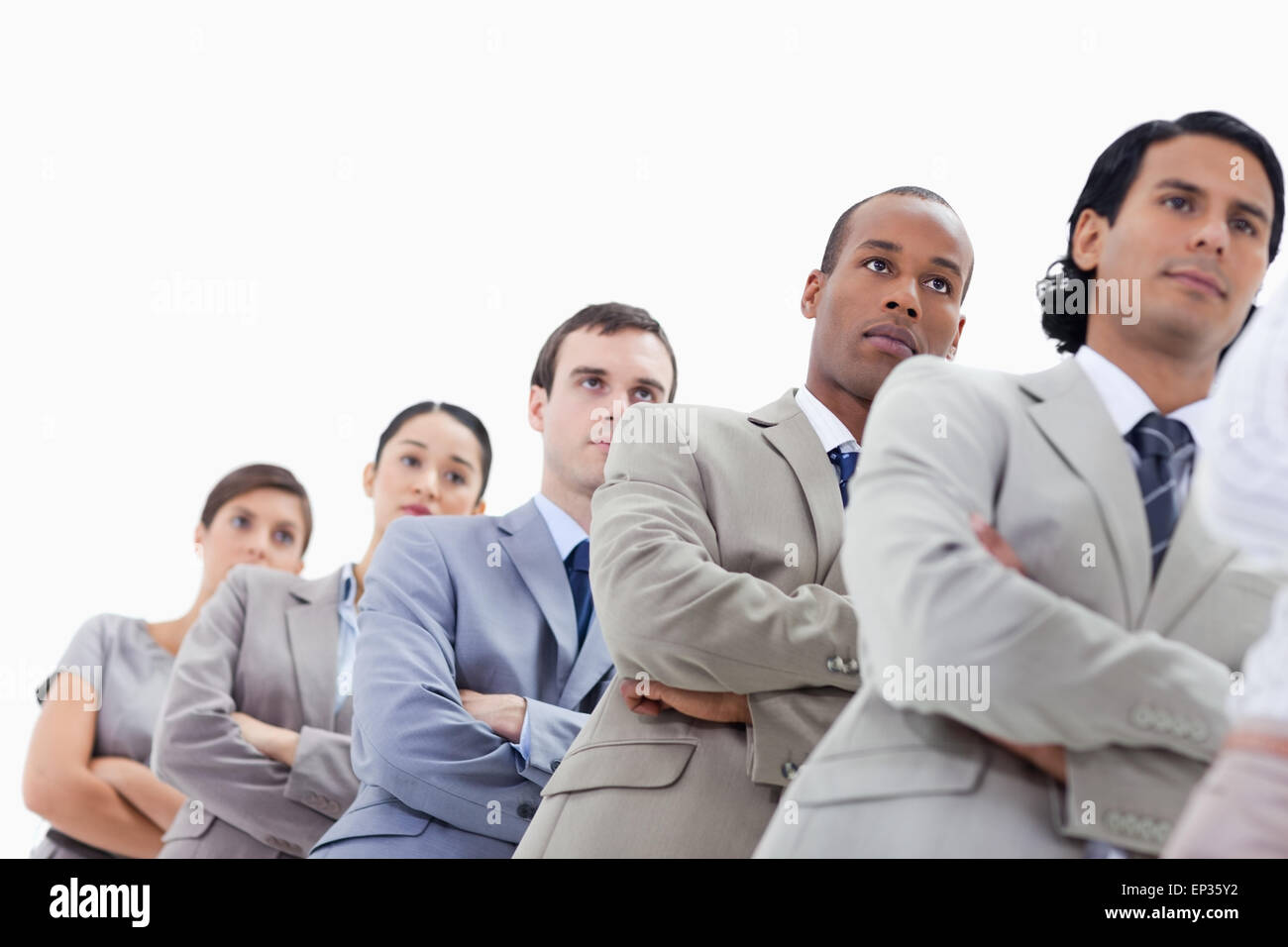 Low-angle shot of a business team crossing their arms in a single line ...