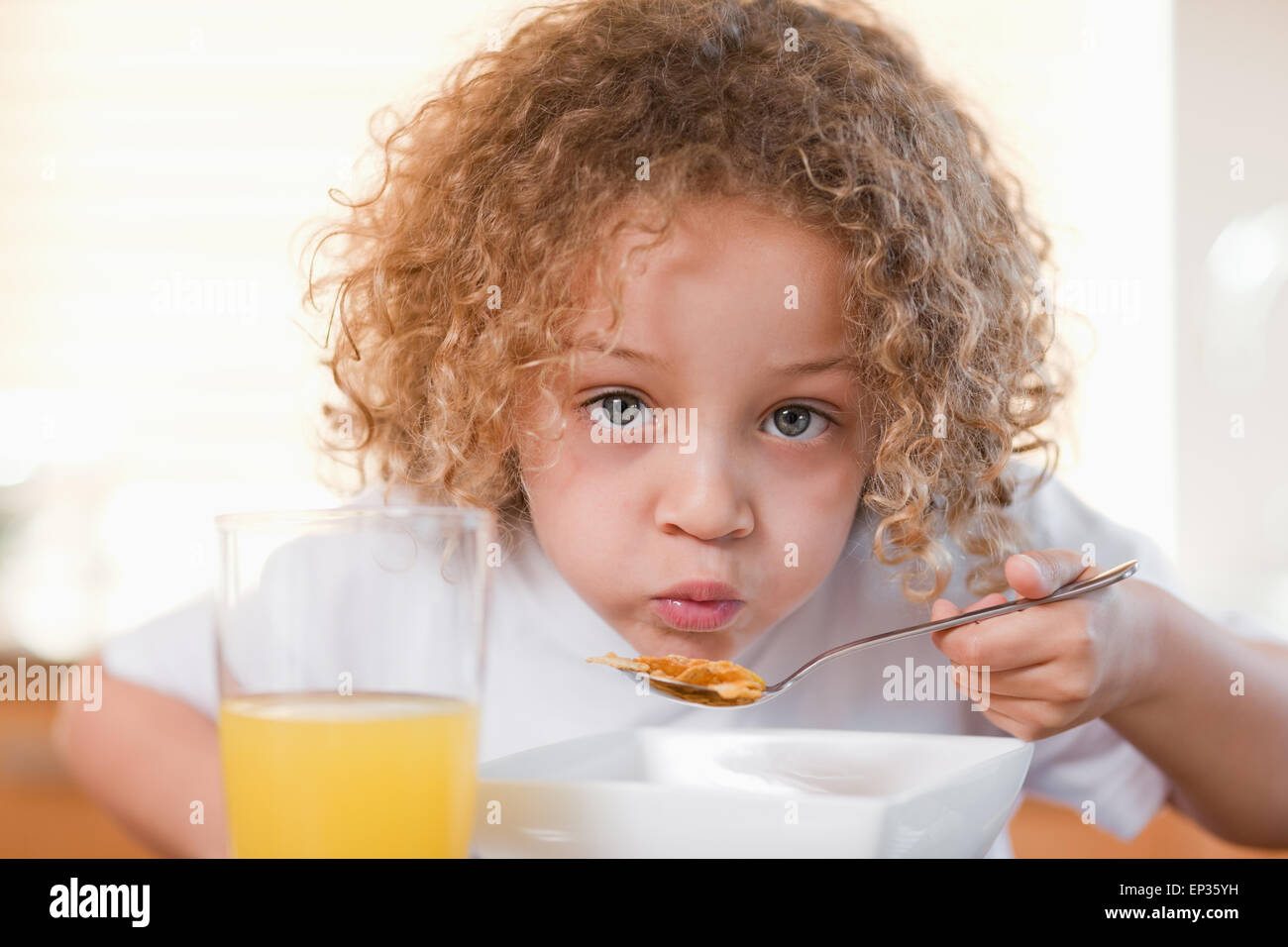 Girl having breakfast in the kitchen Stock Photo - Alamy