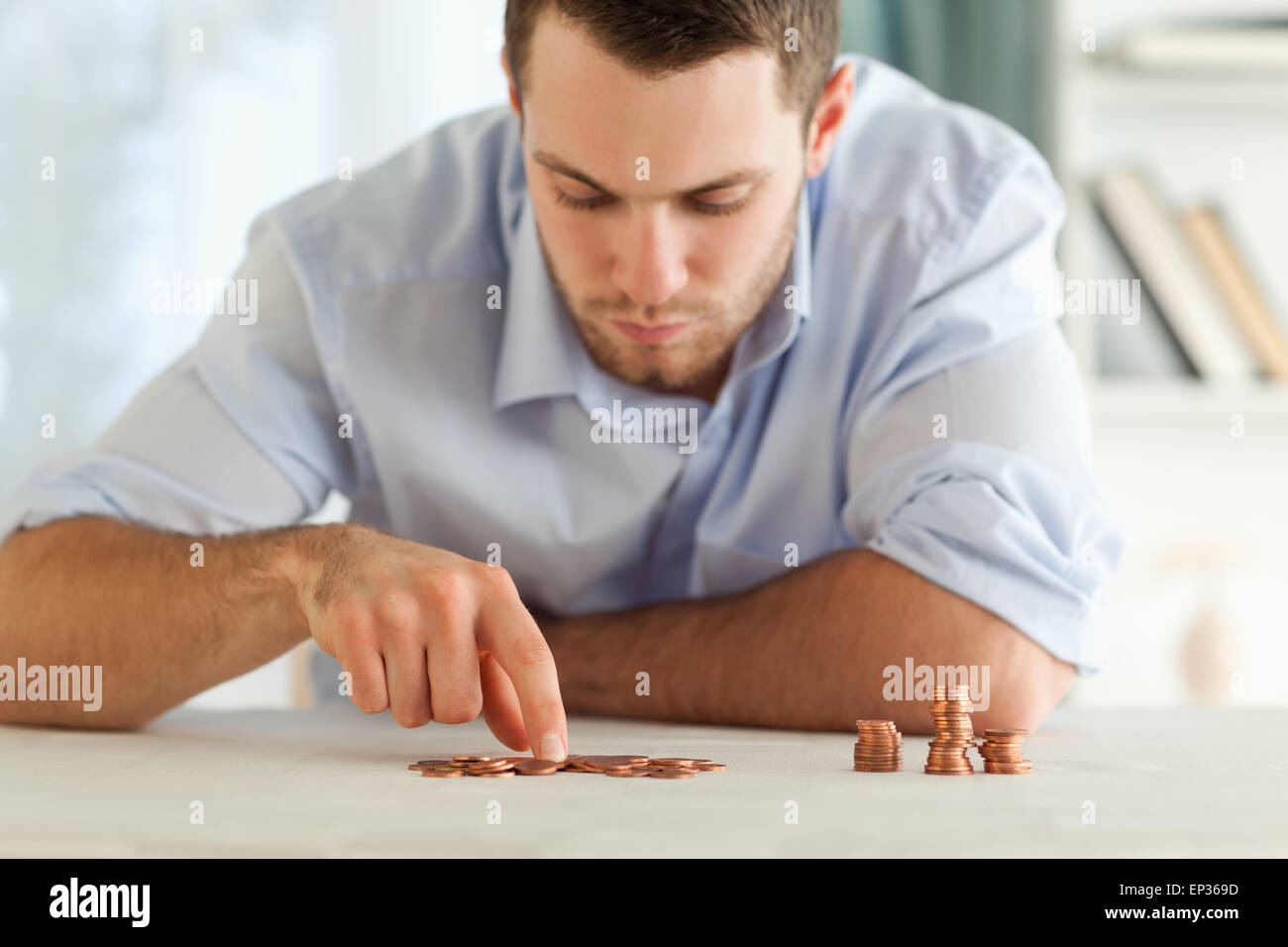 Businessman counting his small coins Stock Photo - Alamy