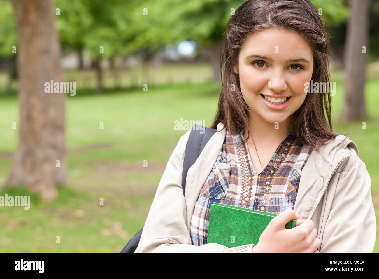Portrait of a first-year student holding a textbook Stock Photo - Alamy