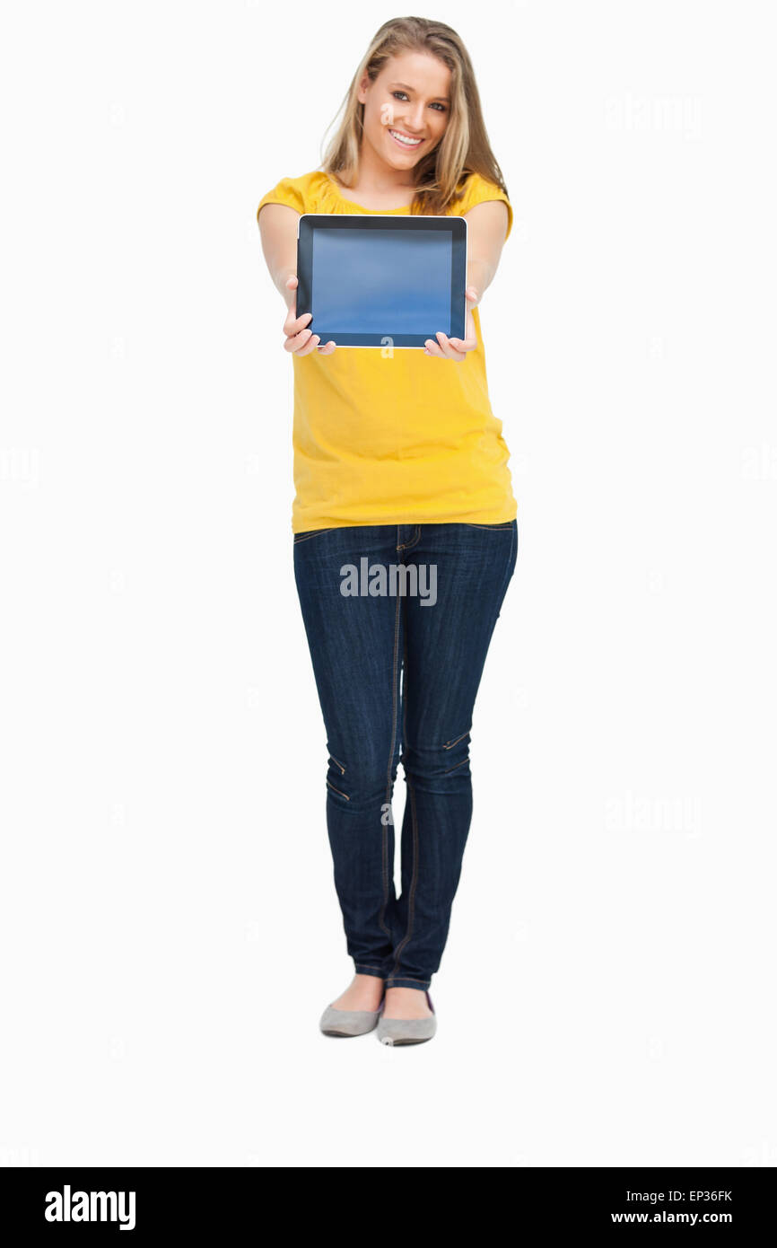 Blonde woman smiling while showing a touch pad screen Stock Photo - Alamy