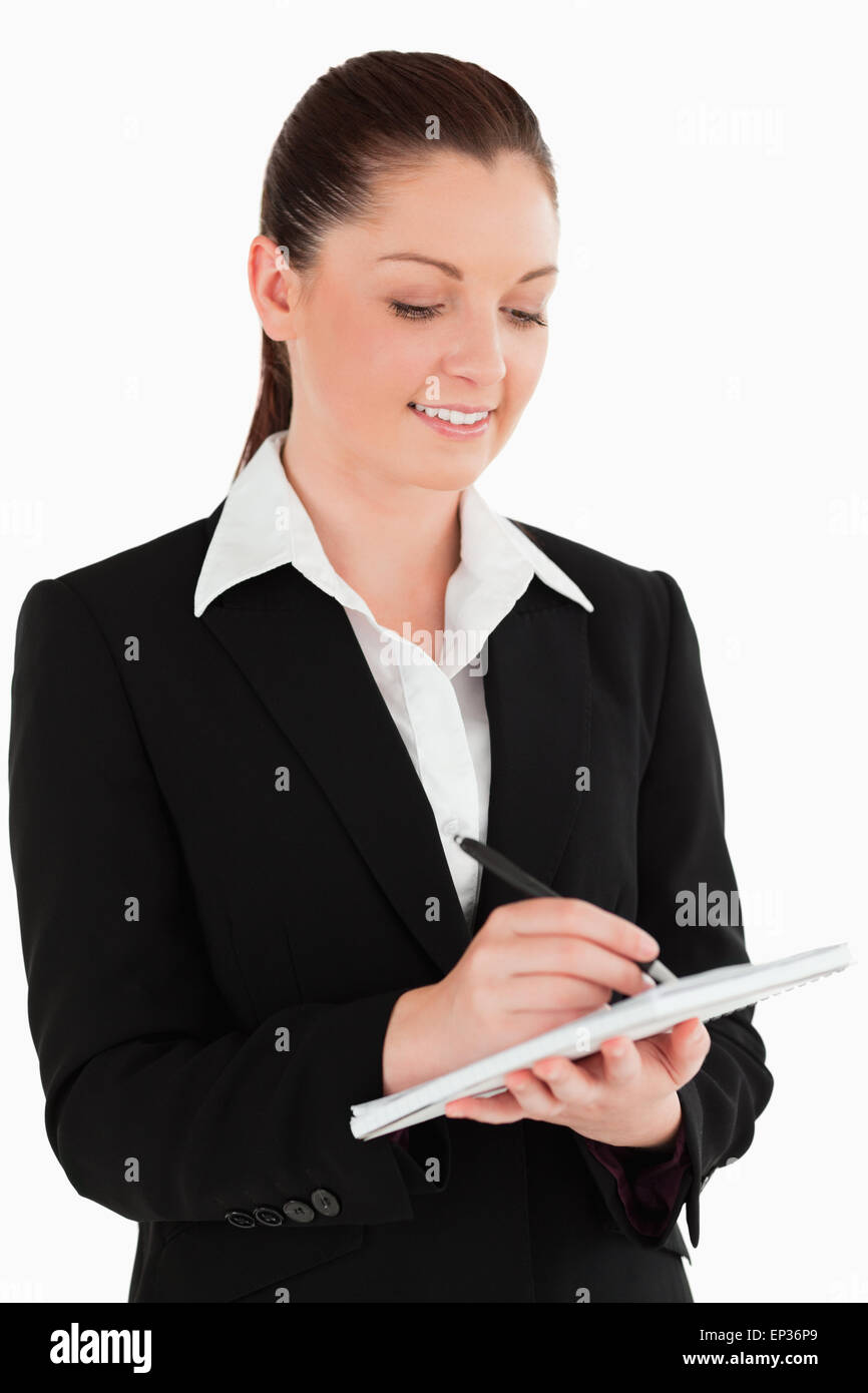 Portrait of a gorgeous woman in suit writing on a notebook Stock Photo ...