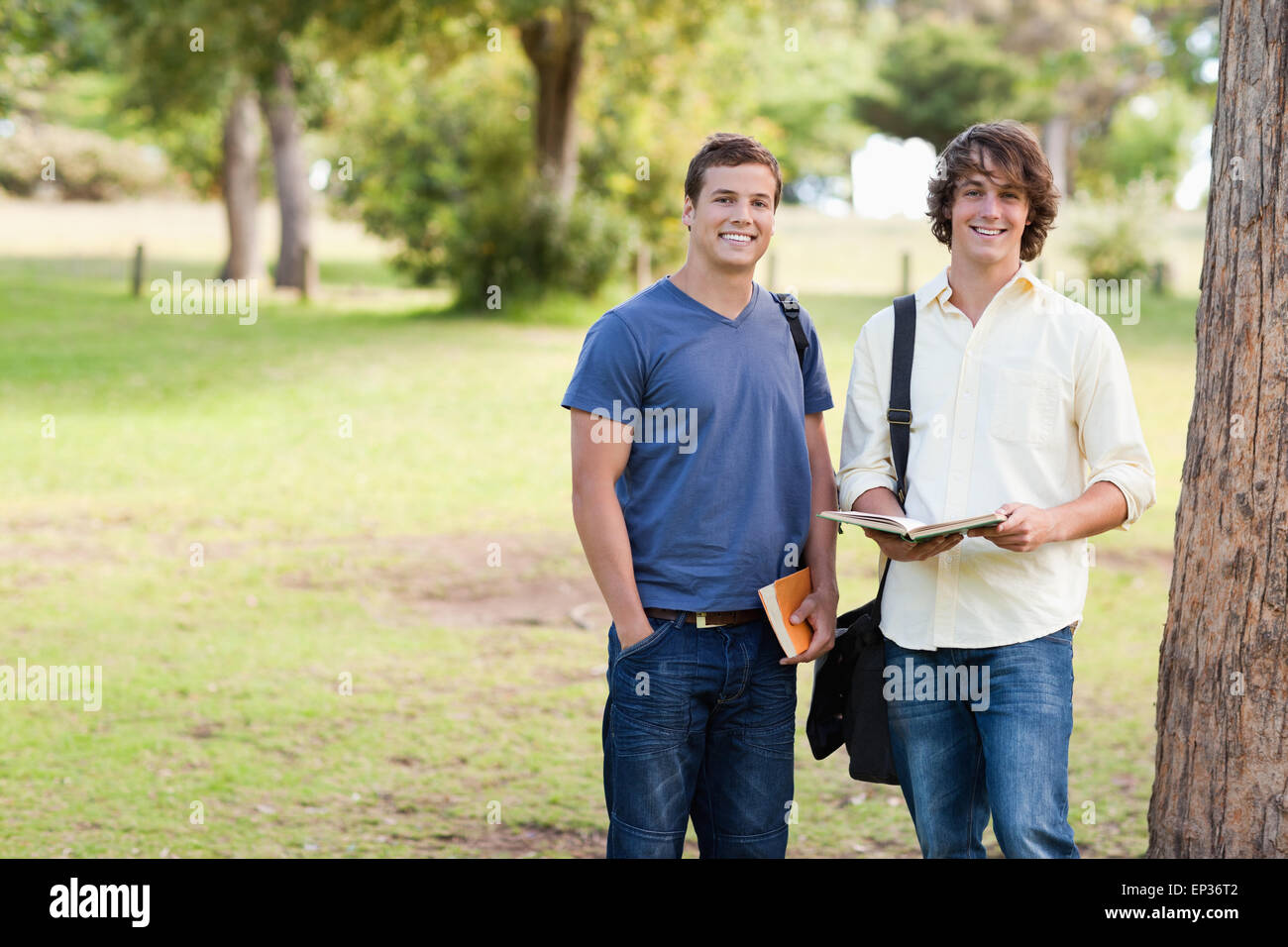 Portrait of two standing male students talking Stock Photo - Alamy
