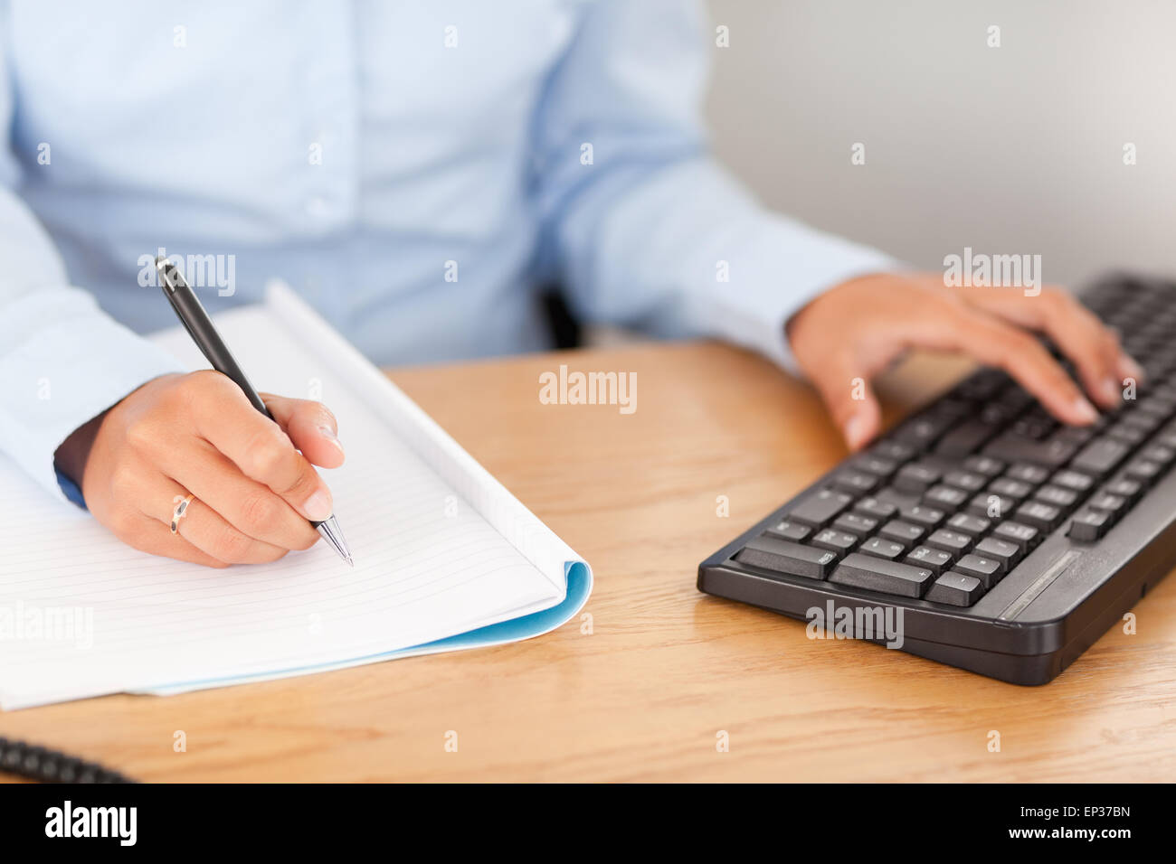gorgeous businesswoman typing and writing Stock Photo - Alamy