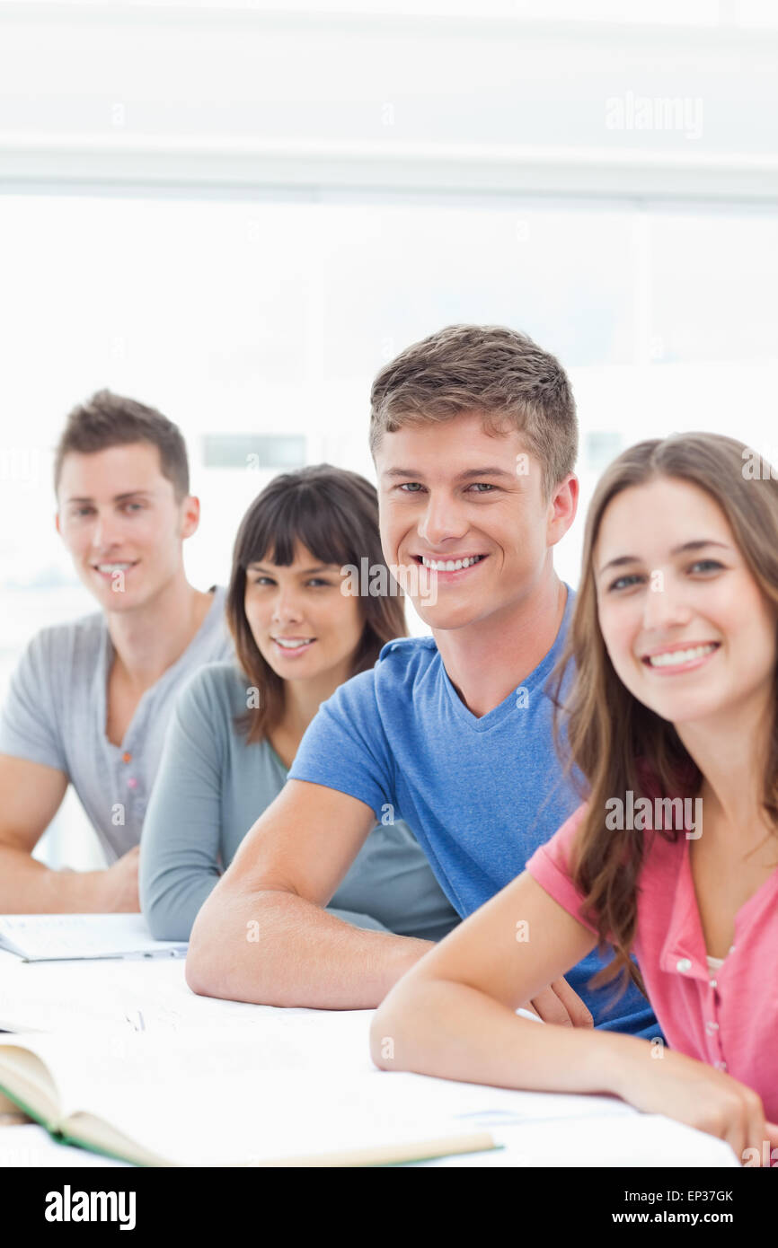 A brightly smiling group of people looking into the camera Stock Photo ...