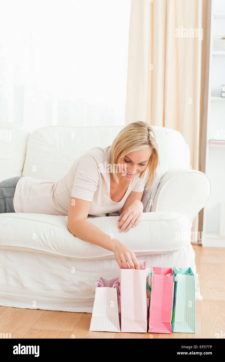 Portrait of a woman looking in her shopping bags Stock Photo - Alamy