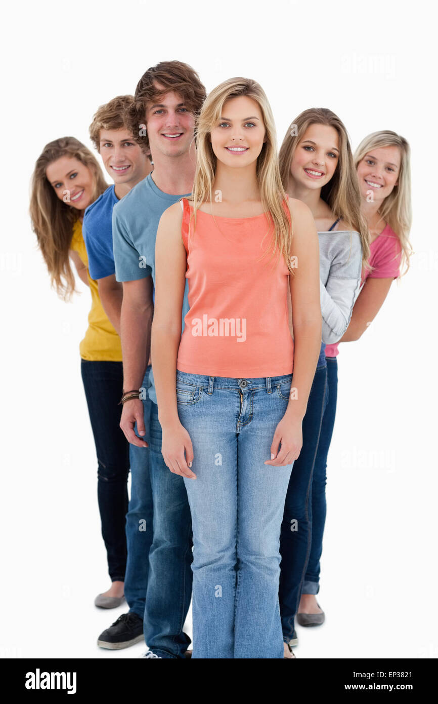 Full length shot of a smiling group standing behind one another at ...