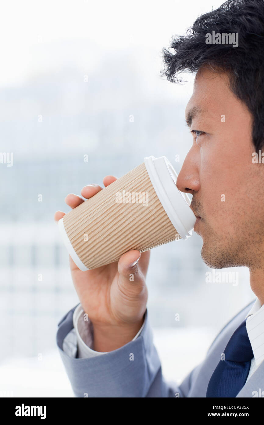 Portrait of an office worker drinking a takeaway coffee Stock Photo - Alamy