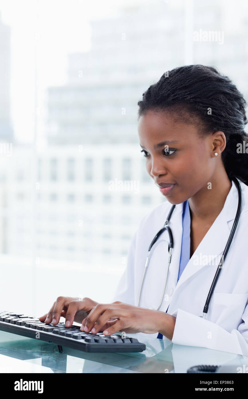 Portrait of a serious female doctor using a computer Stock Photo - Alamy