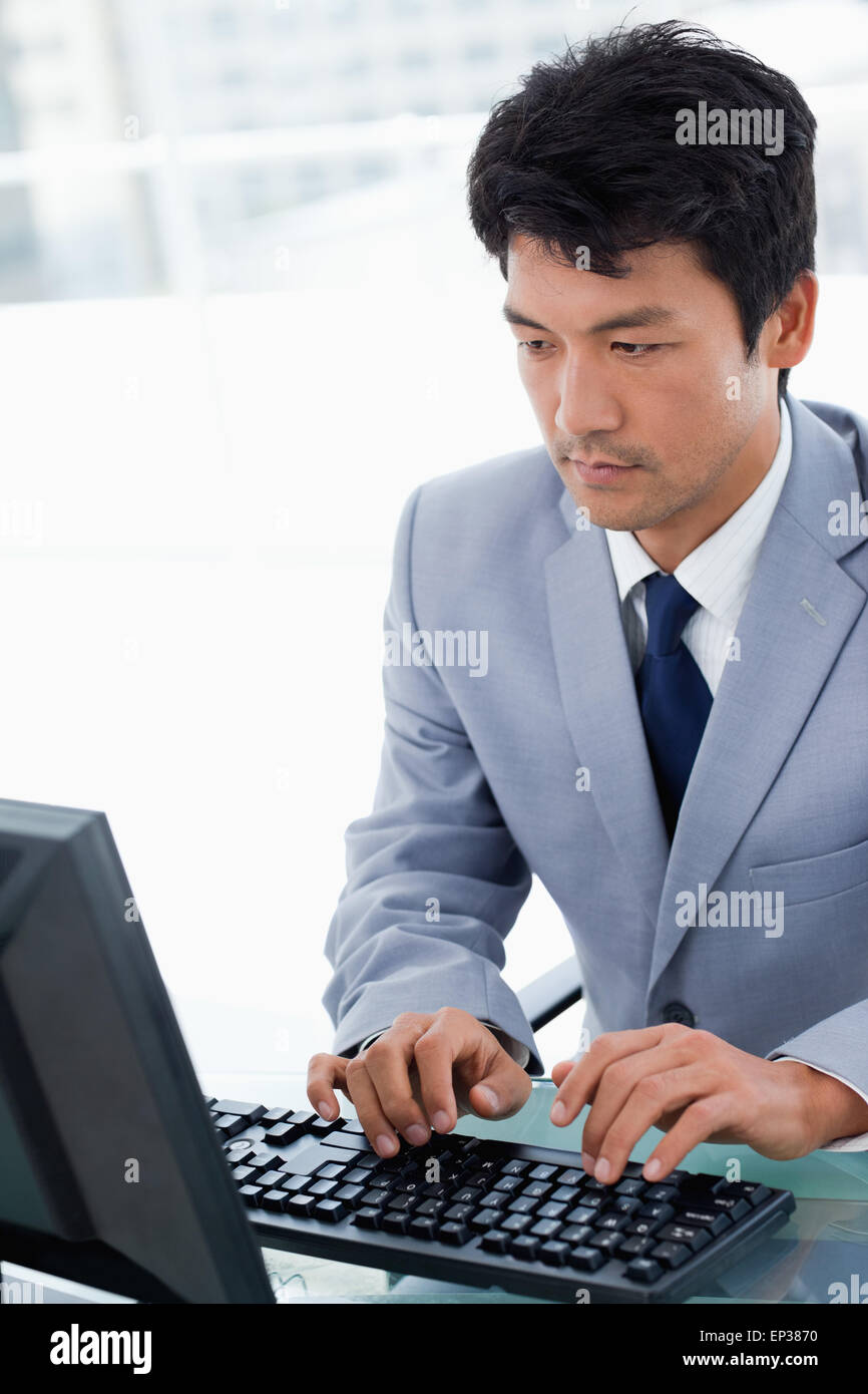 Portrait of a serious manager using a computer Stock Photo - Alamy