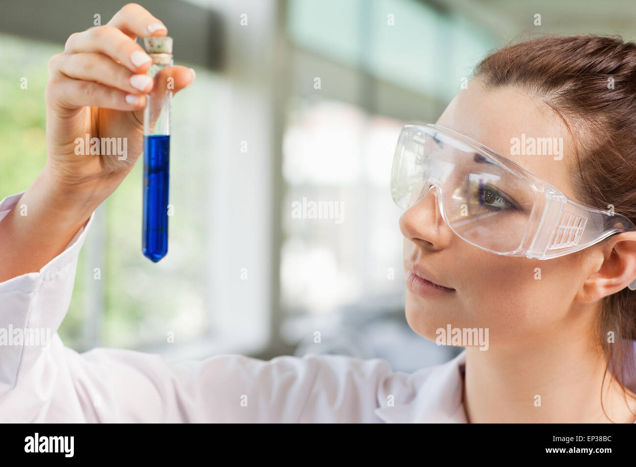 Female science student looking at a test tube Stock Photo - Alamy