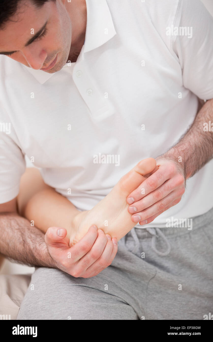 Reflexologist massaging the sole of the patient Stock Photo - Alamy