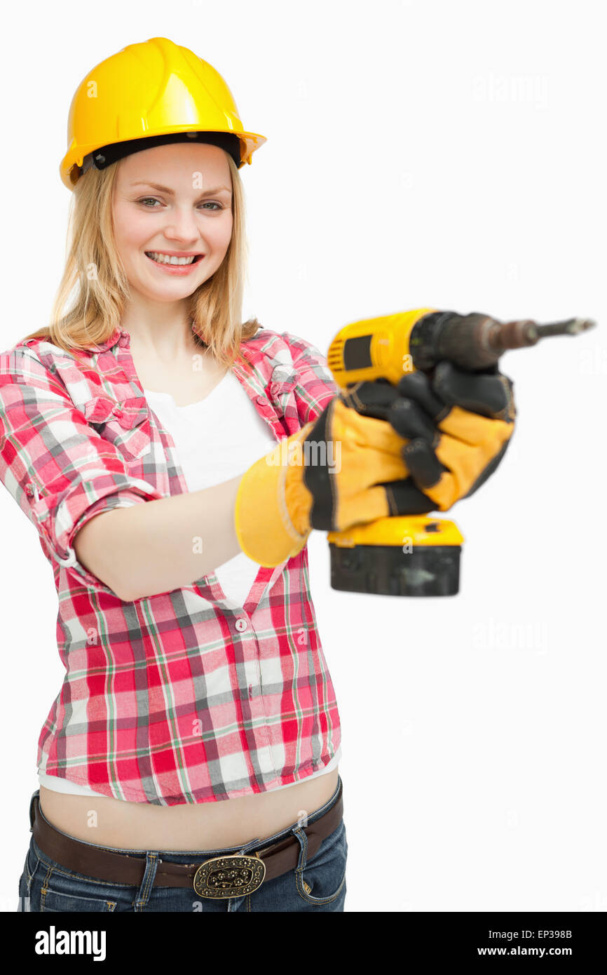 Woman using an electric screwdriver while smiling Stock Photo - Alamy