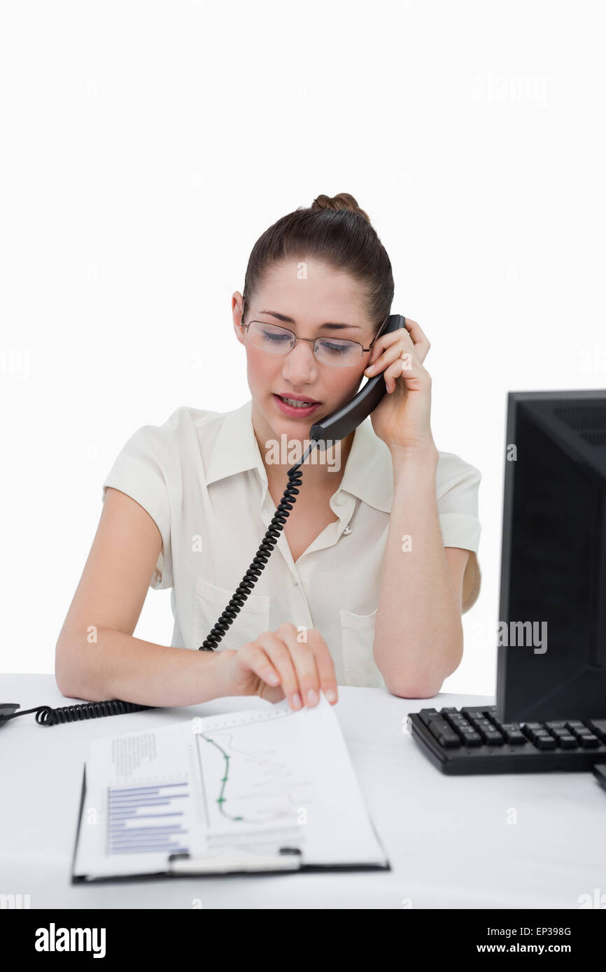 Portrait of a businesswoman making a phone call while looking at a ...