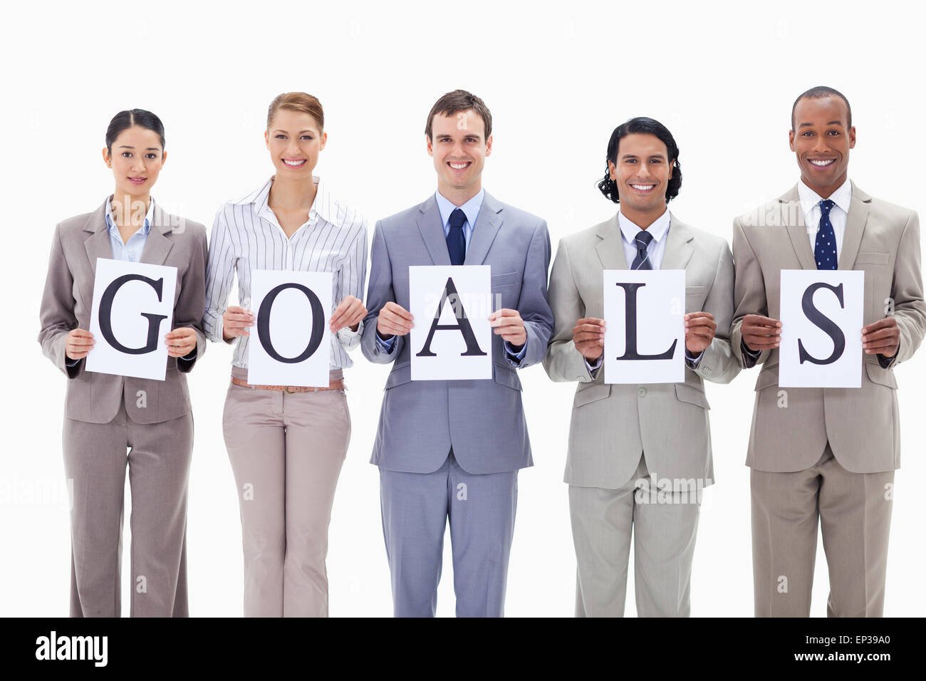 Happy business team holding the letters of GOALS Stock Photo - Alamy
