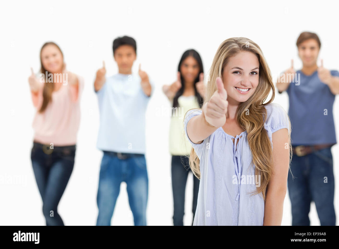Close-up of people smiling and approving with one woman in foreground ...