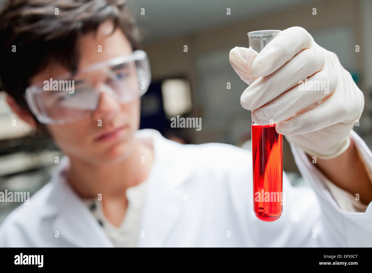 Young scientist holding a test tube Stock Photo - Alamy