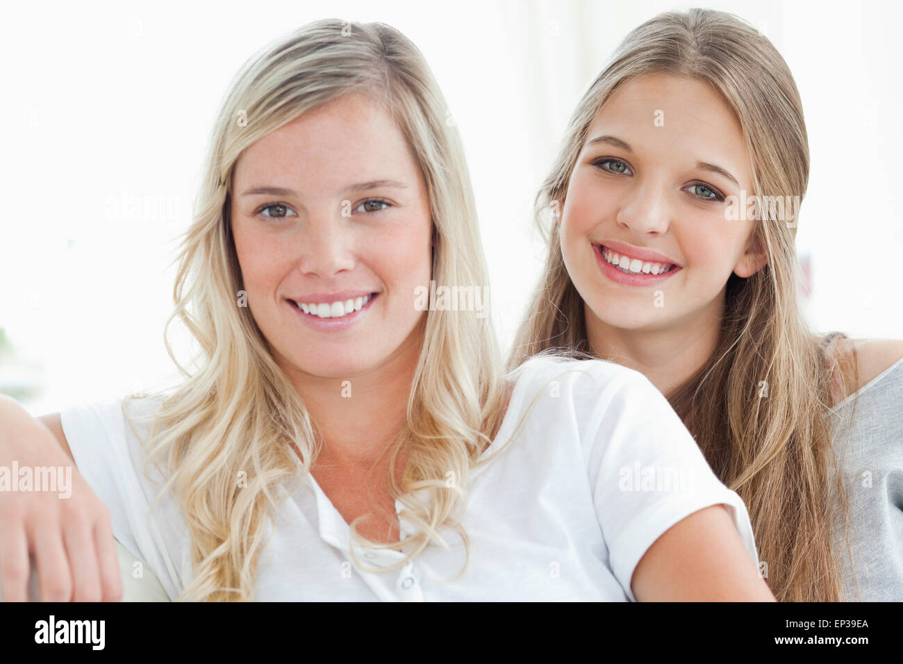 A pair of girls smiling as they look at the camera Stock Photo - Alamy