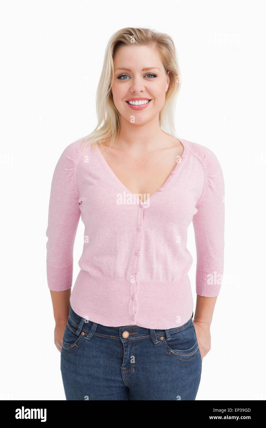 Joyful blonde woman placing her hands in her pockets Stock Photo - Alamy