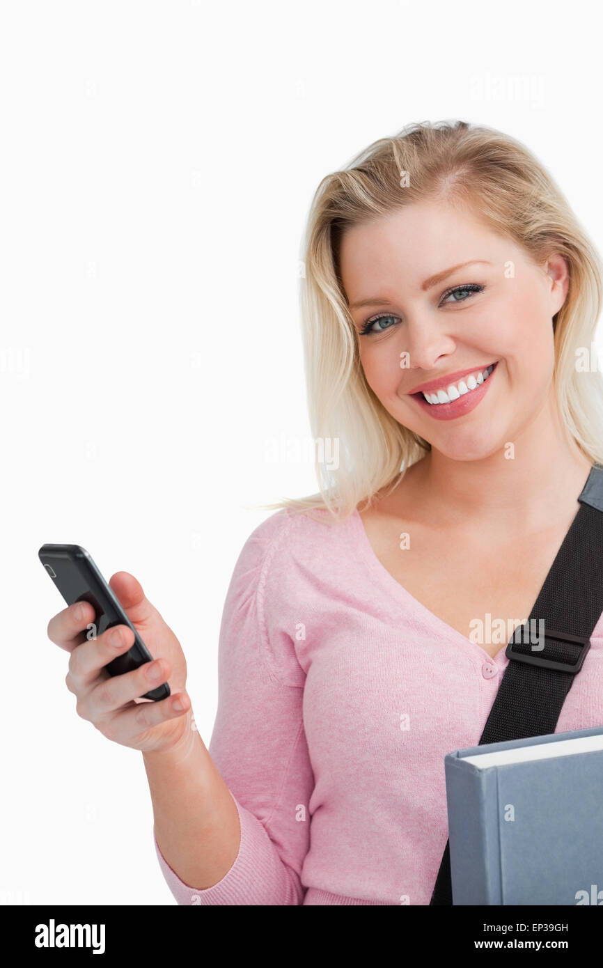 Smiling woman holding her cellphone and a novel Stock Photo - Alamy