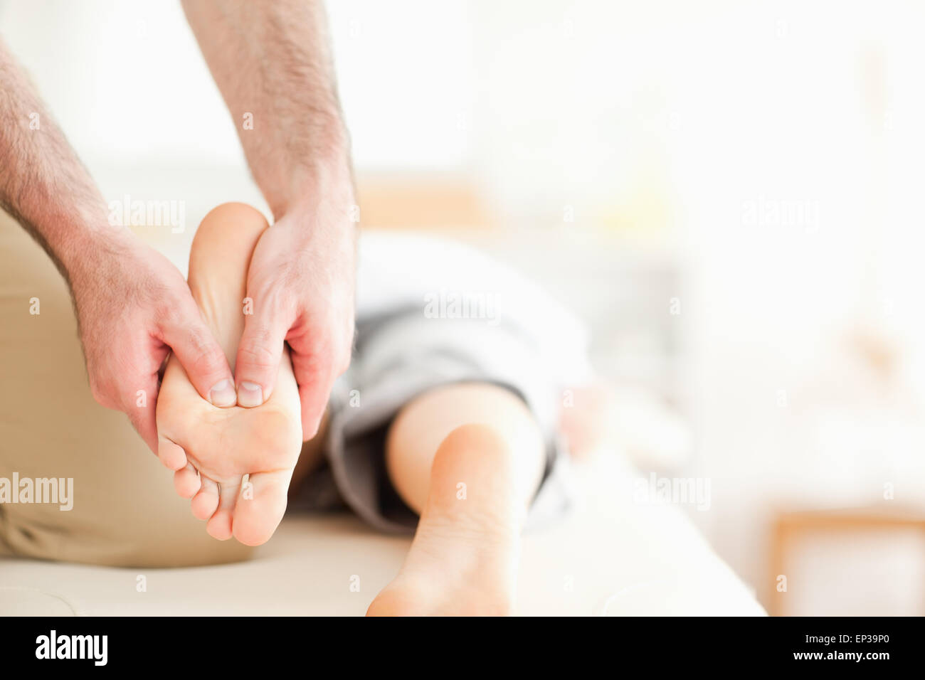 Male masseur massaging feet hi-res stock photography and images - Alamy