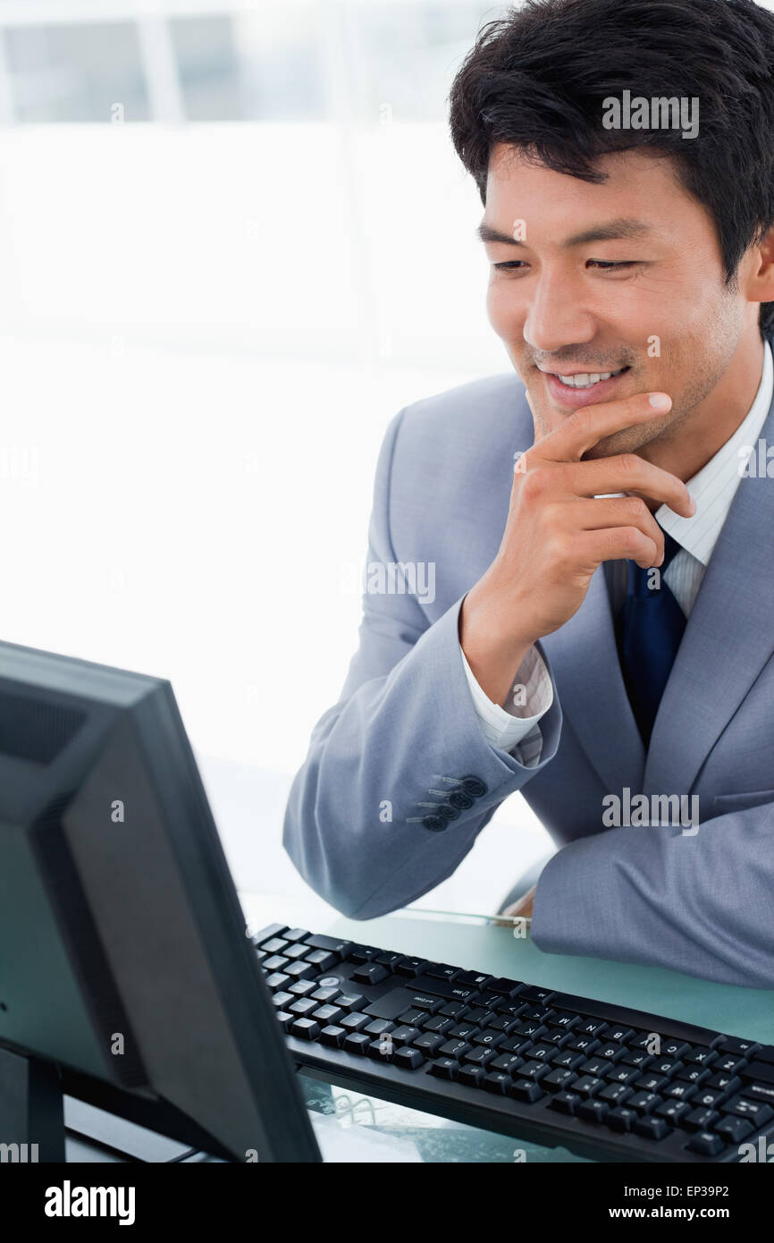 Portrait of a smiling manager using a computer Stock Photo - Alamy