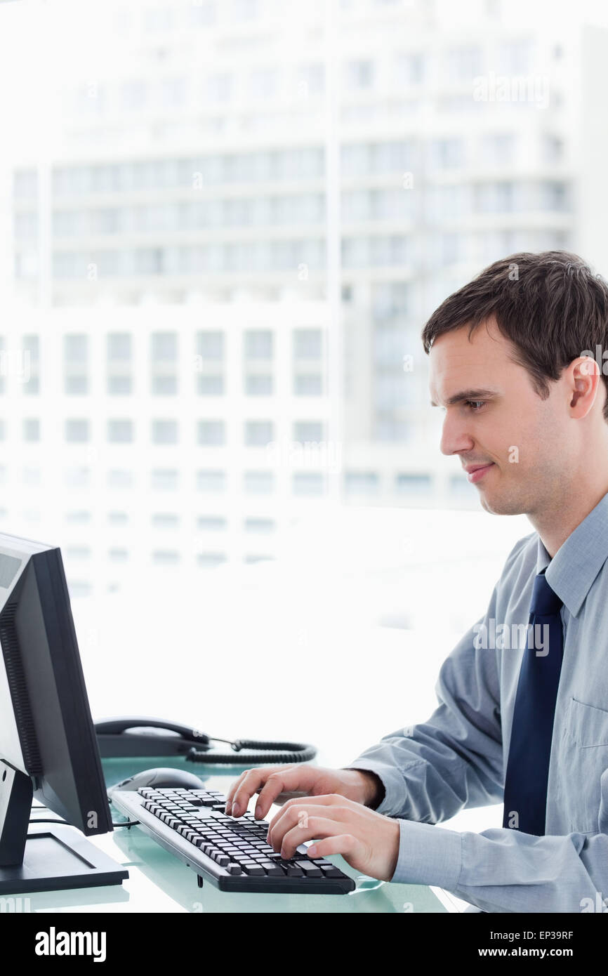 Side view of an office worker using a monitor Stock Photo - Alamy