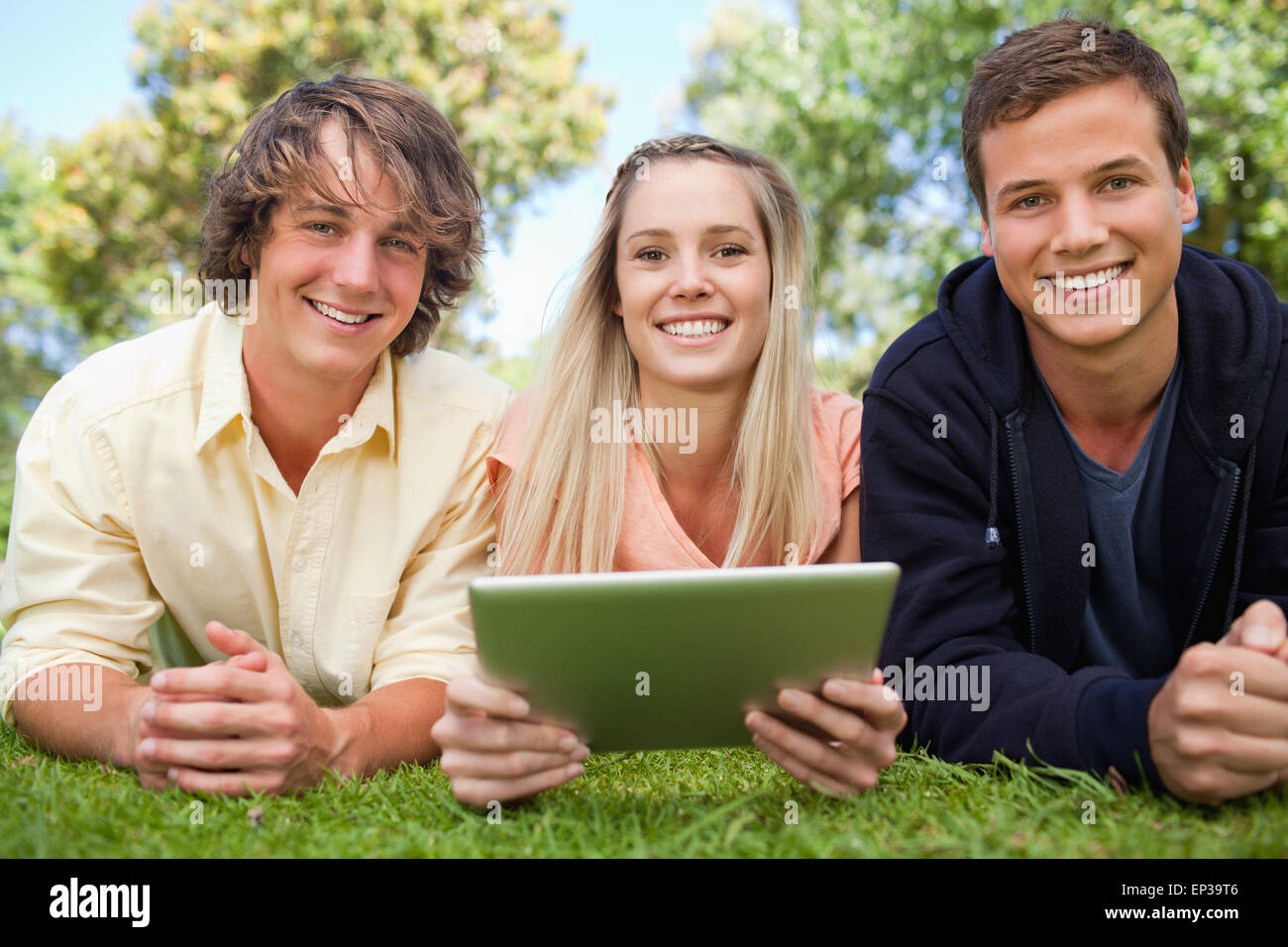 Three smiling students using a tactile tablet Stock Photo - Alamy