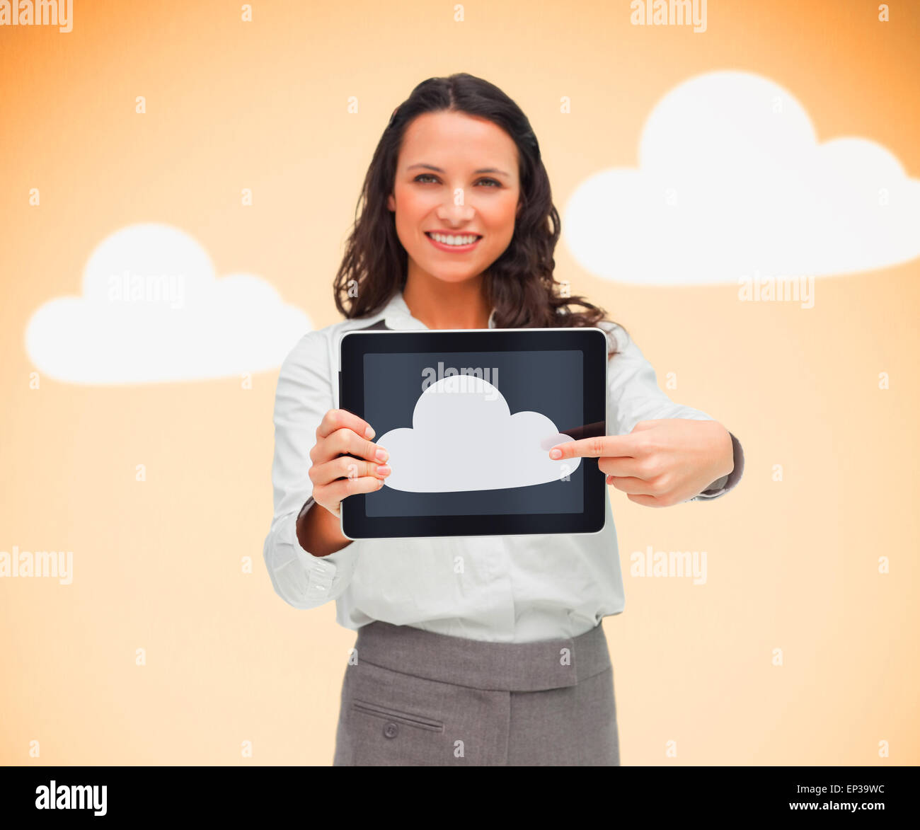 Woman standing while holding a tablet pc pointing to cloud symbol on ...