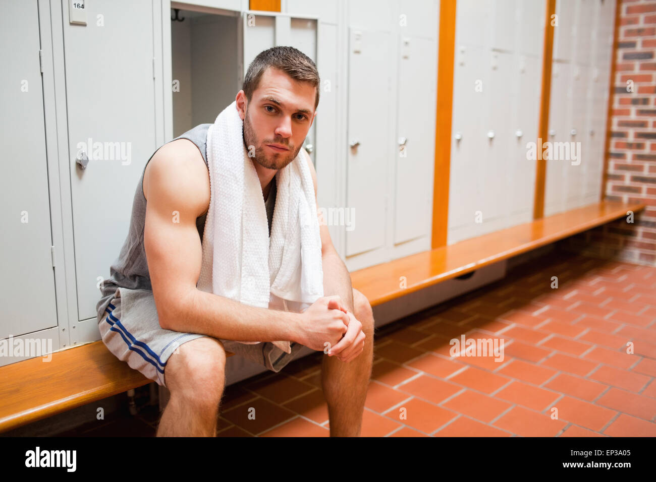 Handsome young sports student sitting on a bench Stock Photo - Alamy