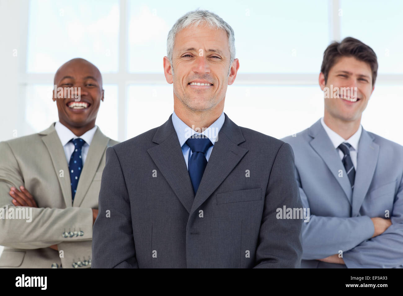 Two young employees standing in the back while laughing and being led ...