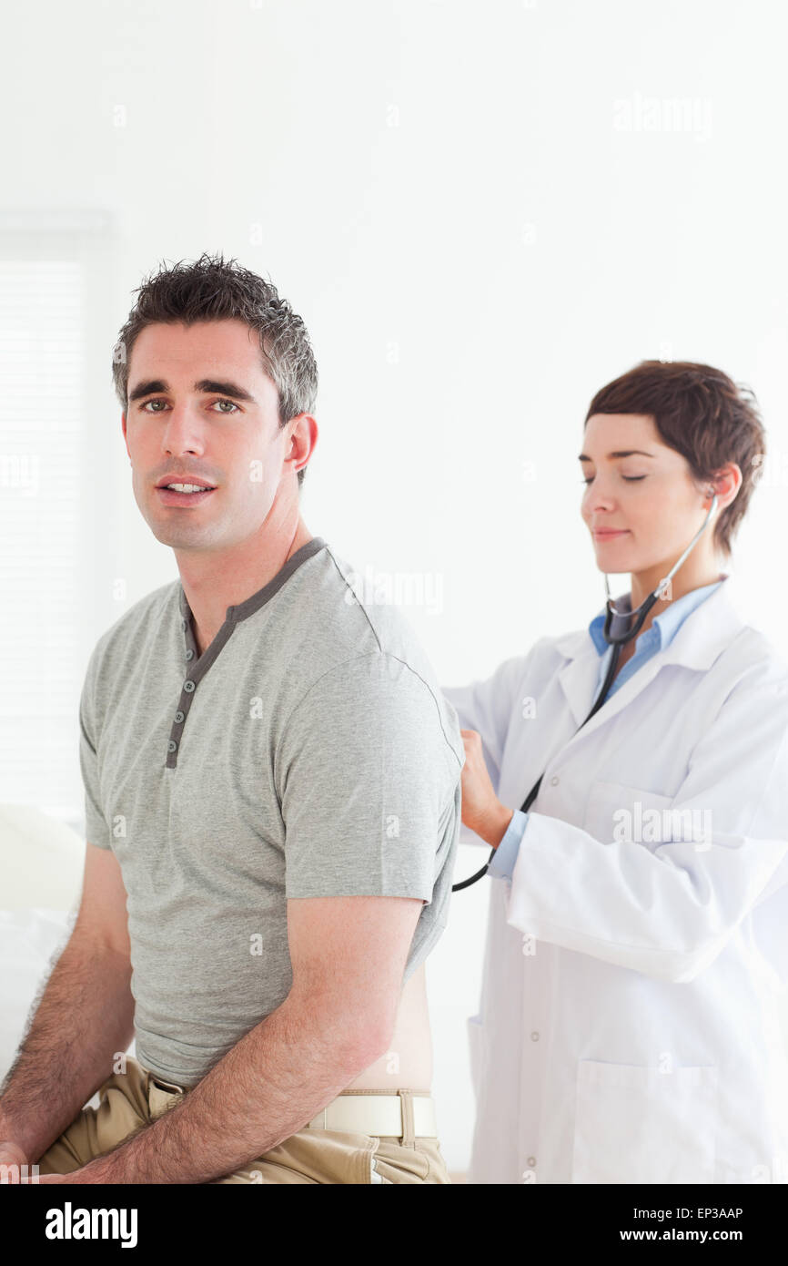 Doctor examining a patient with a stethoscope Stock Photo - Alamy