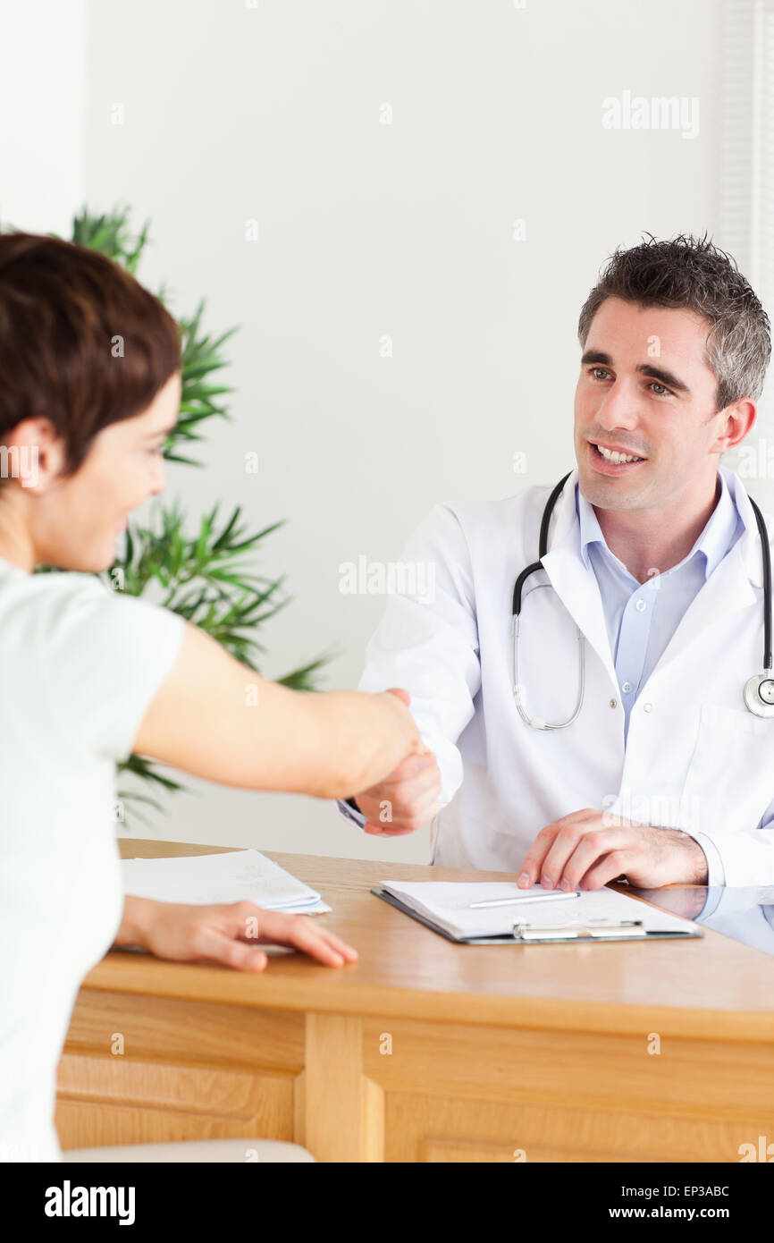 Male Doctor greeting a patient Stock Photo - Alamy
