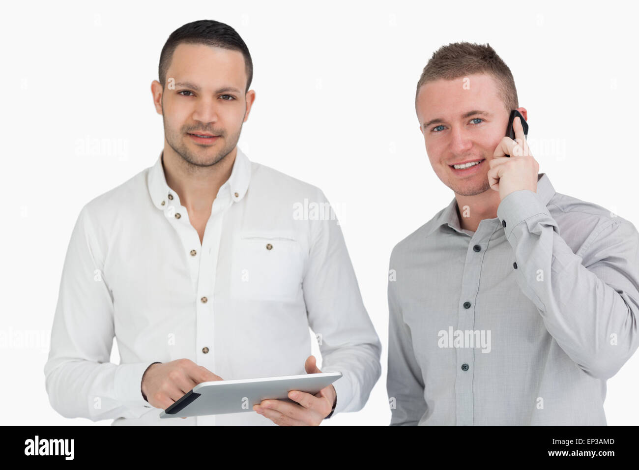 Two smiling men with a phone and a tablet computer Stock Photo - Alamy