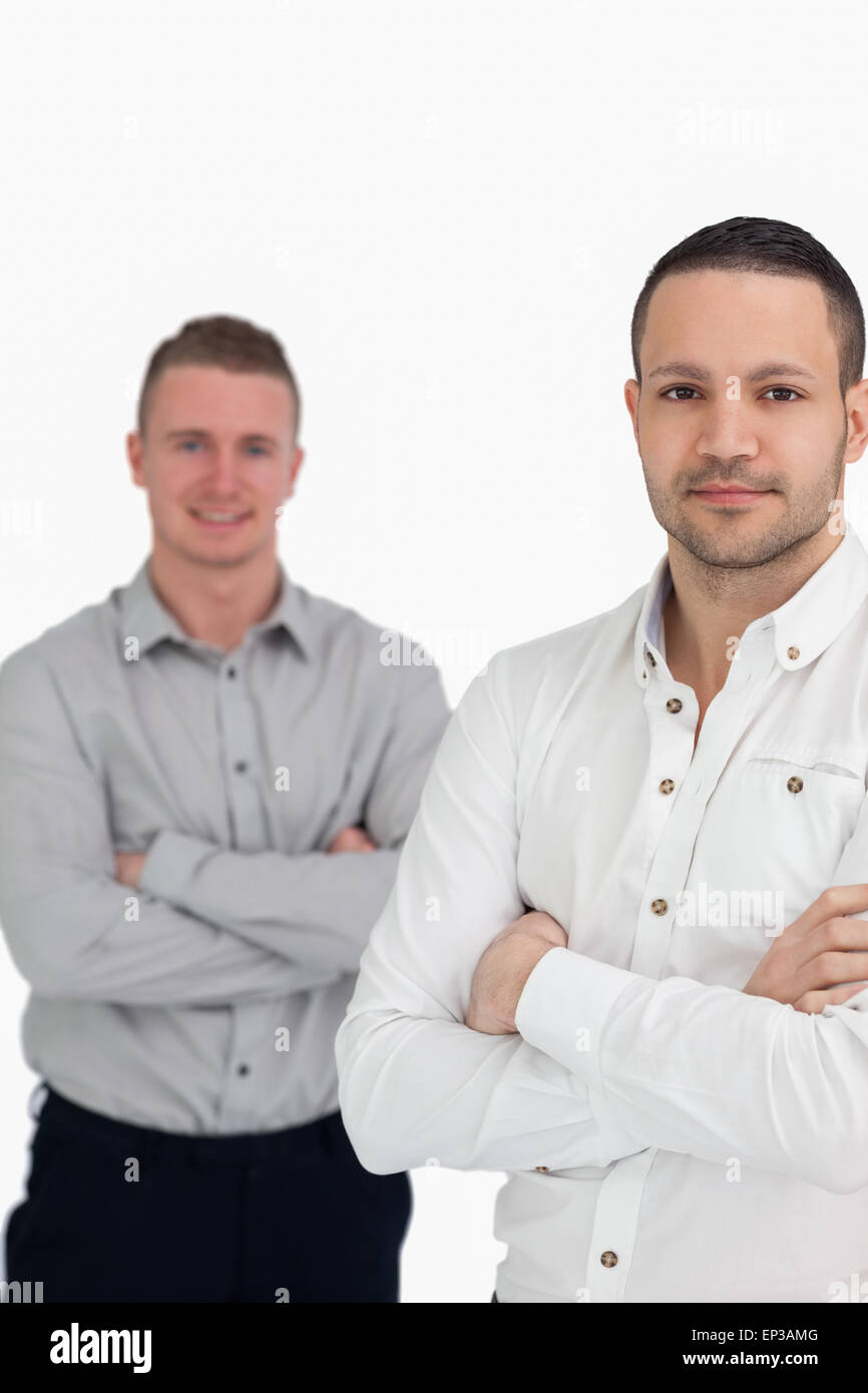 Two men crossing their arms as they stand up Stock Photo - Alamy