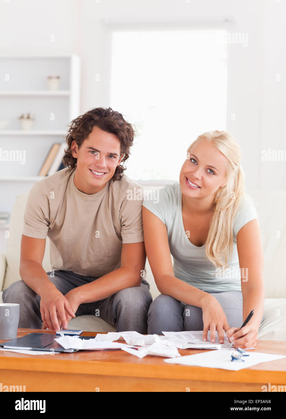 Happy couple calculating Stock Photo - Alamy