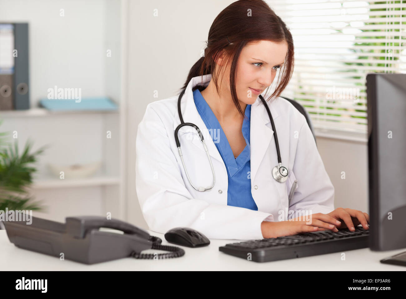 Female doctor typing on keyboard Stock Photo - Alamy