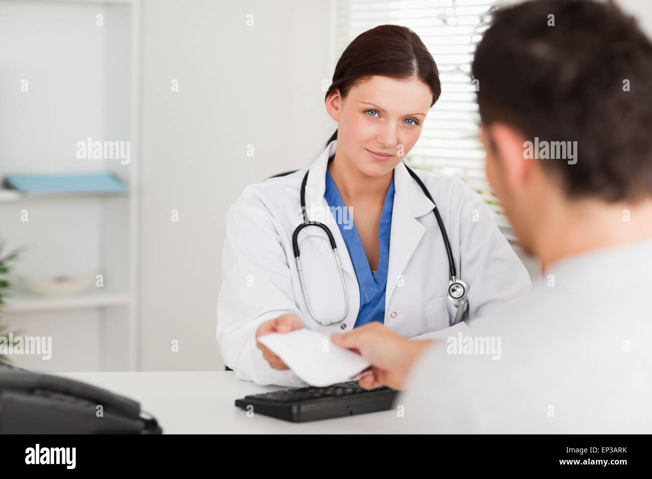 Female doctor giving patient a prescription Stock Photo - Alamy