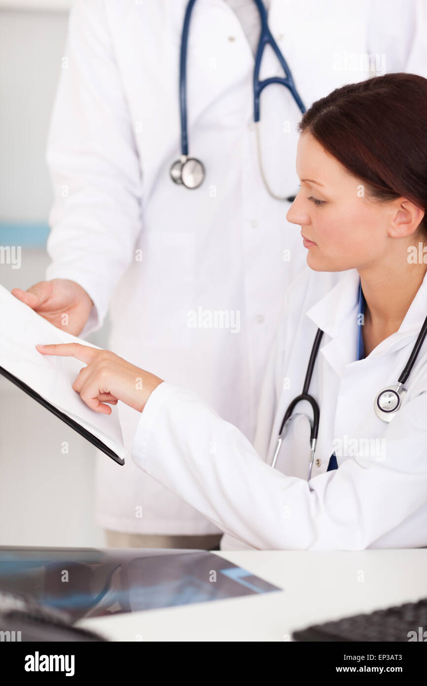 Female doctor pointing on file Stock Photo - Alamy