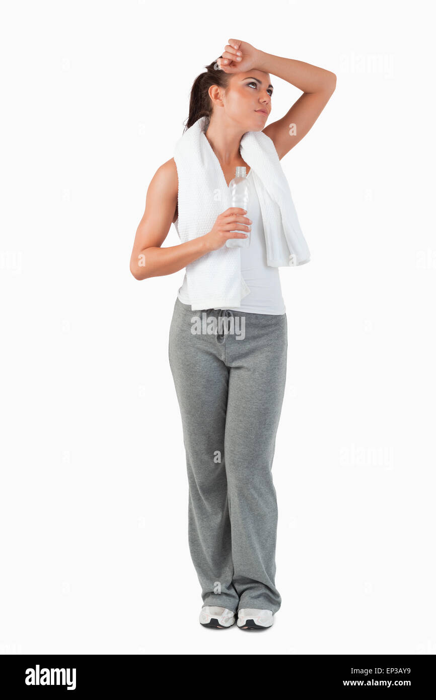 Young woman wiping off sweat from her forehead Stock Photo - Alamy