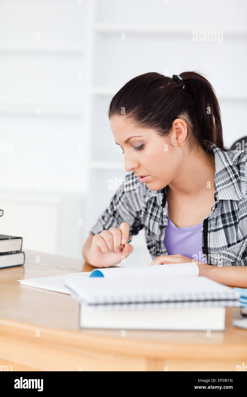 Young student learning between books Stock Photo - Alamy