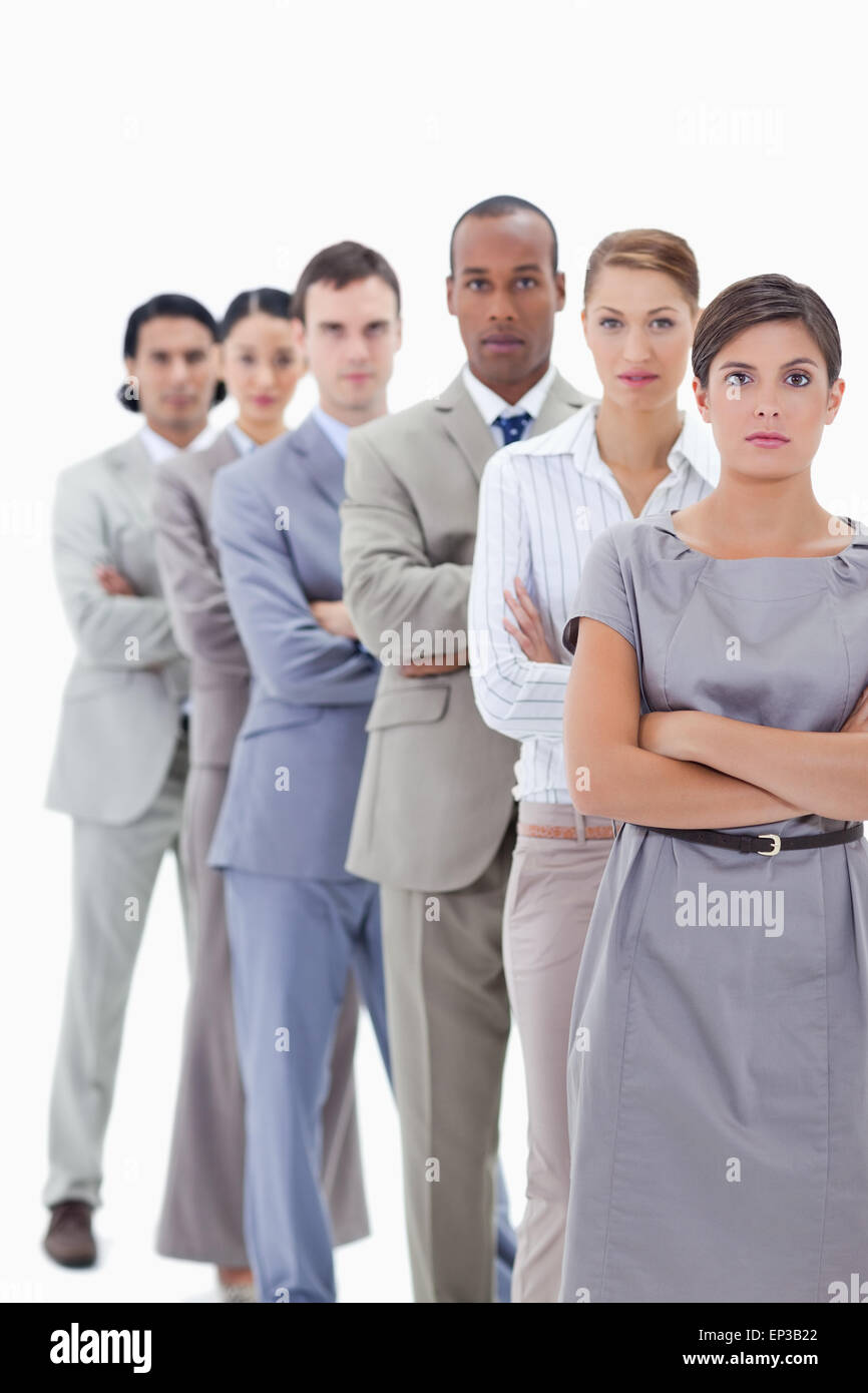 Close-up of a serious business team in a single line crossing their ...