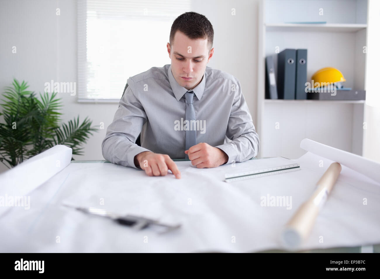 Architect working on construction plan Stock Photo - Alamy