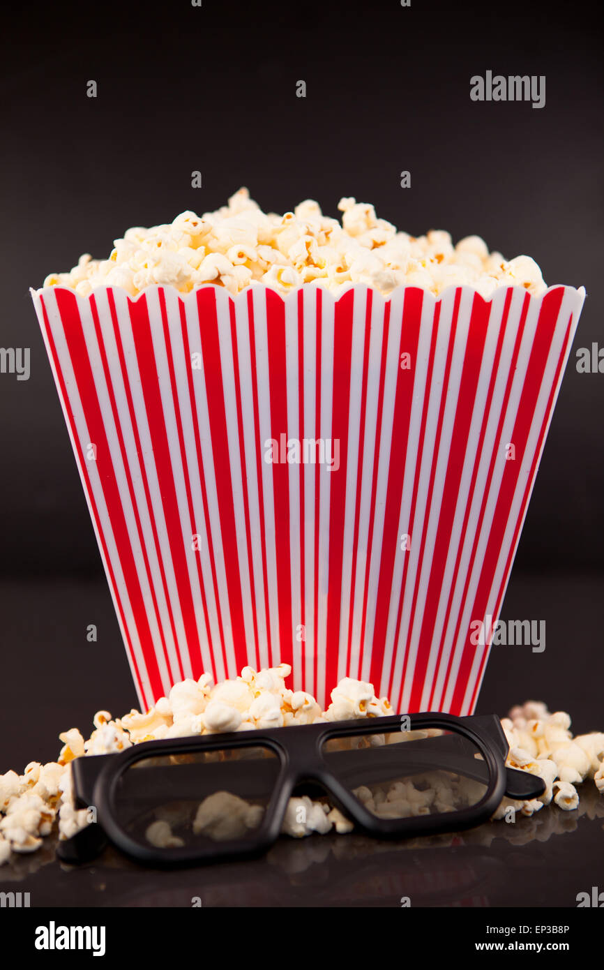 3D glasses on popcorn at the feet of a box of popcorn Stock Photo - Alamy